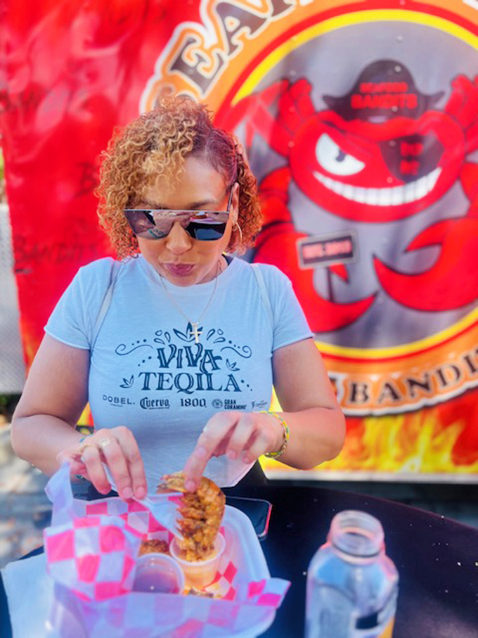 Every great food experience has a human element. This diner knows she's about to embark on a seafood adventure worth documenting.