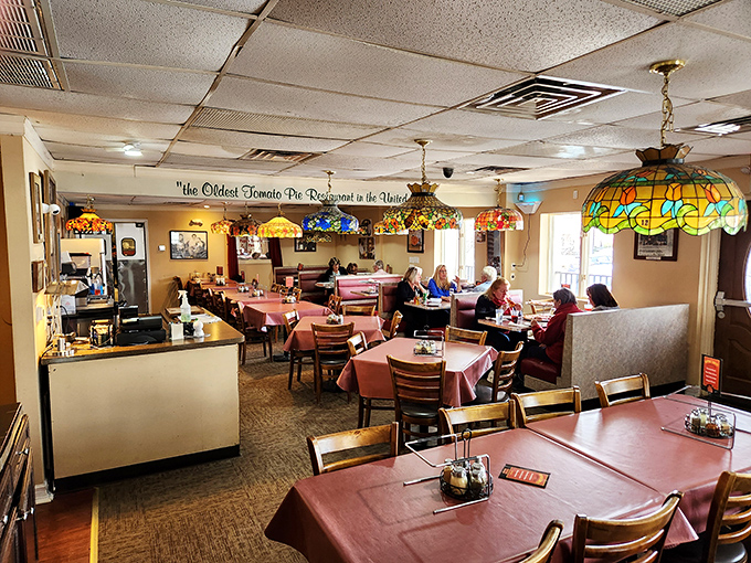 Lunchtime at a living legend. The mix of booths and tables accommodates both regulars who've been coming for decades and first-timers about to have their pizza worldview changed.