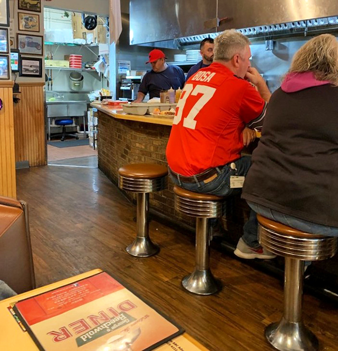 The counter is where the magic happens. Ohio State fans and locals sharing space, stories, and the universal language of "pass the ketchup."
