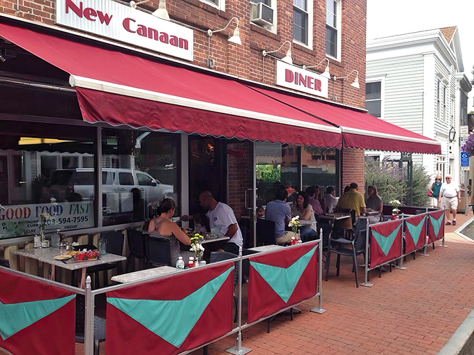 The red awning creates an oasis on New Canaan's brick sidewalks. A perfect spot to watch the world go by between bites.