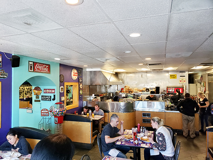 A bustling dining room where strangers become temporary neighbors, united by the universal language of "pass the ketchup, please."