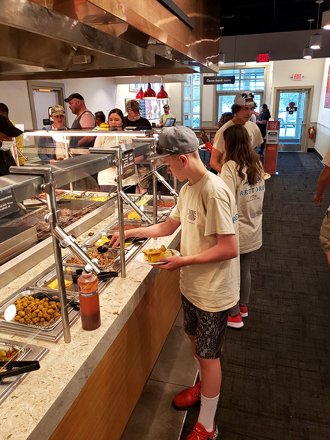 Young diners navigate the buffet line with plates in hand, learning early that unlimited choices require both strategy and self-control in equal measure.