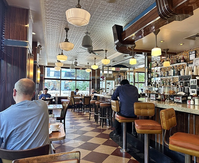 Morning light streams through windows as patrons settle in for that perfect combination: good food, better coffee, and New York people-watching.