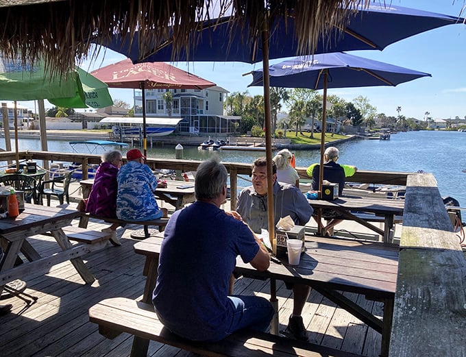 Waterfront dining where conversations flow as smoothly as the canal waters. Notice how nobody's checking their phones?