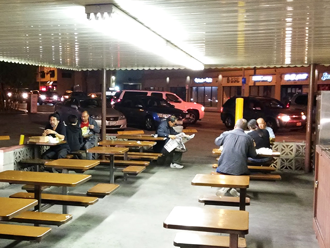 Late-night diners finding solace under fluorescent lights. Some of life's best conversations happen over pastrami at picnic tables.