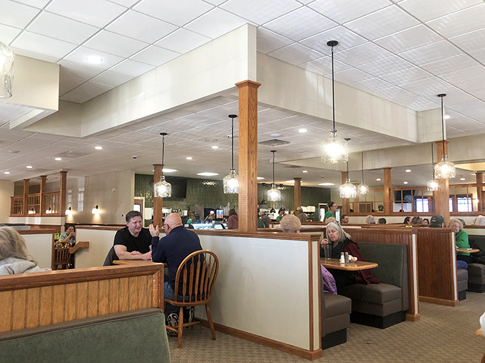 Modern pendant lighting meets classic booth seating &ndash; proving Busy Corner knows comfort never goes out of style, even when the decor gets updates.