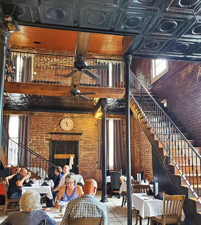 Soaring ceilings and exposed brick create a dining cathedral where conversations flow as freely as the wine&mdash;a two-story experience for all five senses.