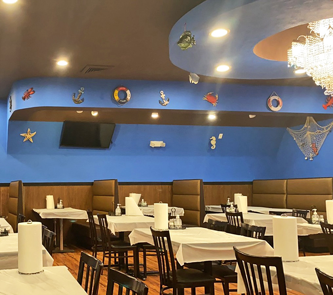 The dining area's blue walls and nautical touches transport you to a coastal getaway. Every table promises the possibility of seafood bliss.
