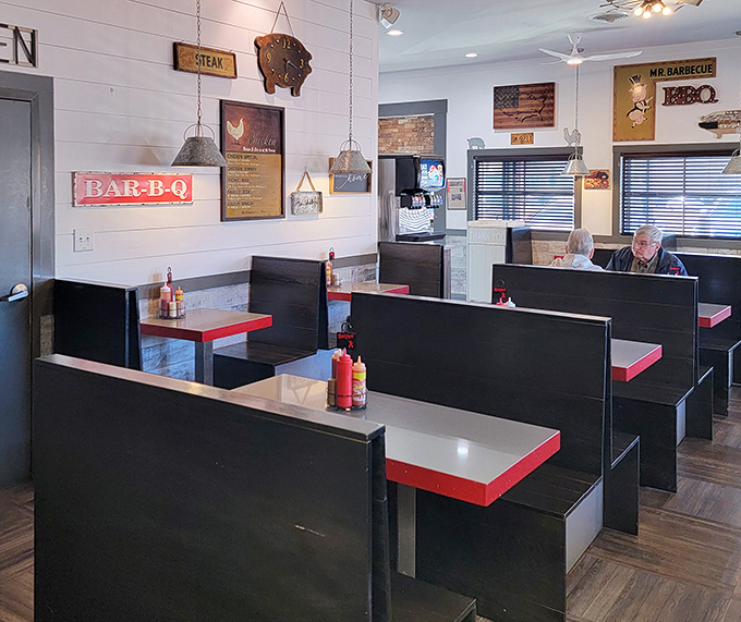 Red-trimmed tables and wood-paneled walls create the perfect backdrop for the serious business of barbecue appreciation and community connection.