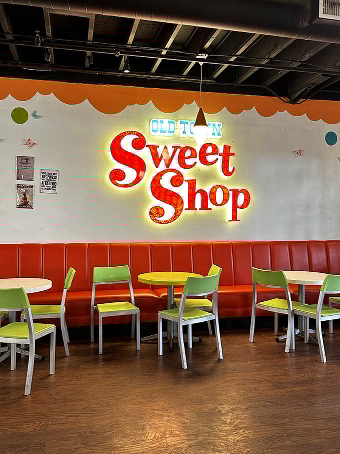 The seating area pops with retro diner vibes. That neon sign isn't just decoration—it's practically a bat signal for sweet-toothed superheroes.