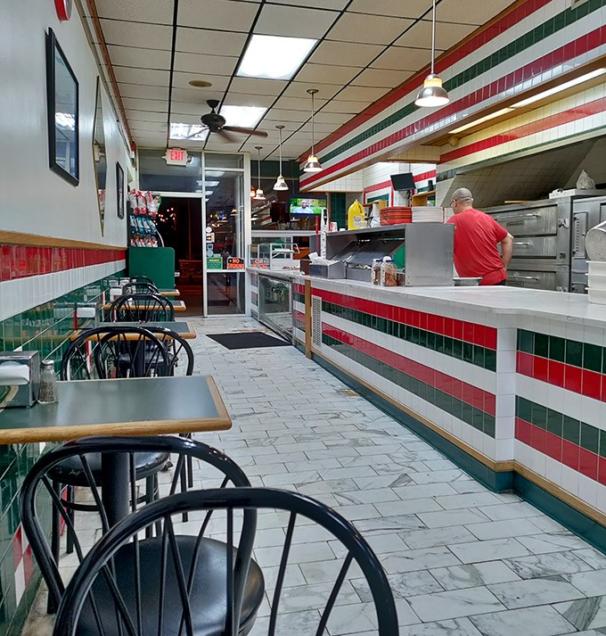 The narrow dining area with its classic Italian color scheme offers a no-frills setting where the food remains the undisputed star.