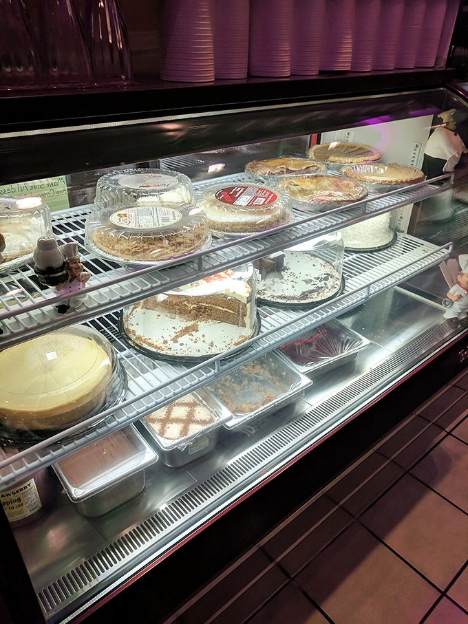 The dessert case &ndash; where willpower goes to die a glorious death. Those pies aren't just desserts; they're edible works of art waiting for their moment.