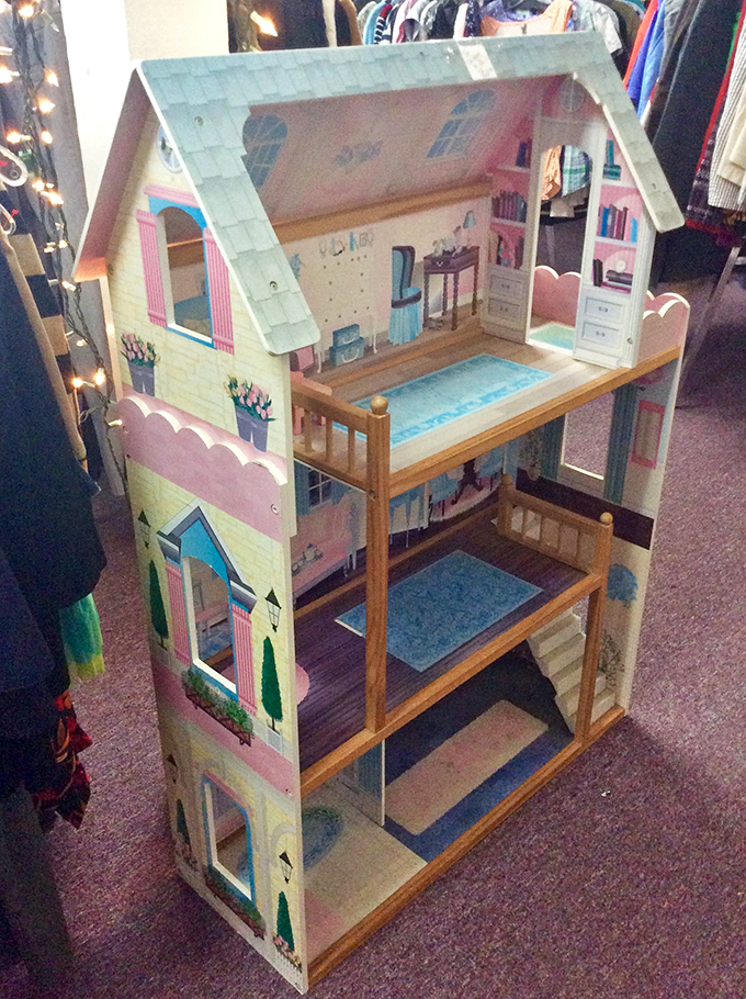 A dollhouse that's seen more careful restoration than some actual houses. Some lucky child is about to inherit a miniature dream home.