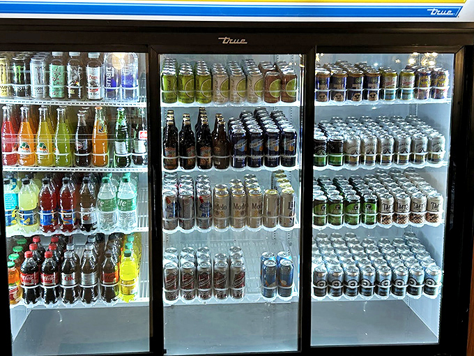 The drink cooler stands ready like a refreshment arsenal, stocked with everything you need to tame the fire of that spicy burger.