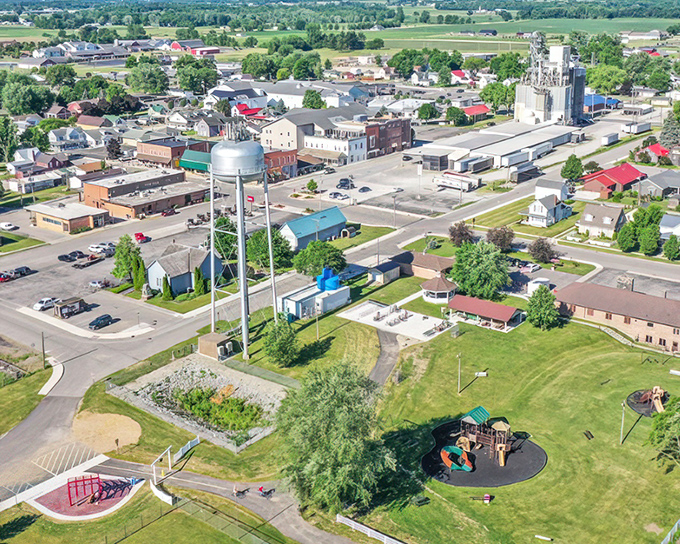 This aerial perspective shows a town where grain silos and white church steeples define the skyline instead of corporate logos.