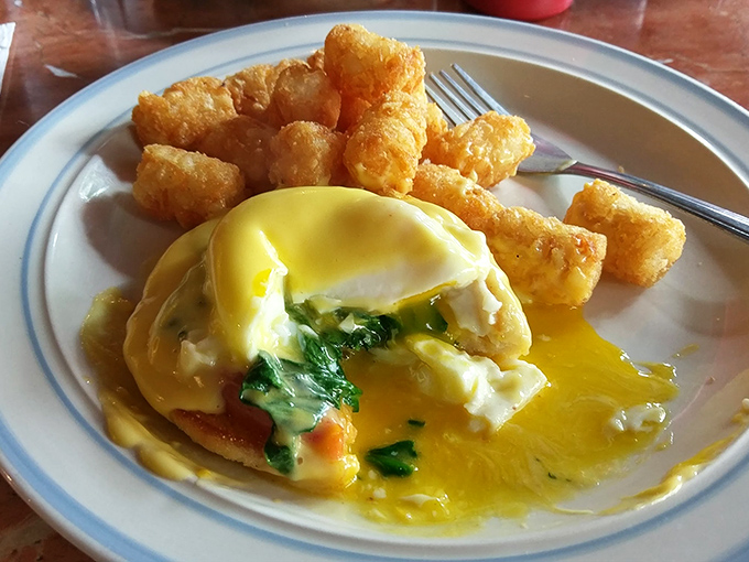 Eggs Benedict that breaks the yolk-tension with dramatic flair. Those tater tots aren't just along for the ride&mdash;they're essential supporting characters in this breakfast drama.