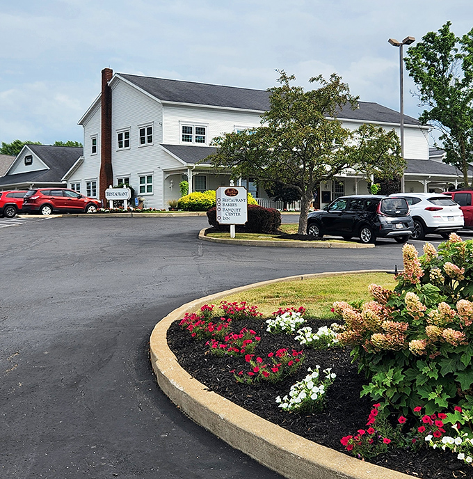 The entrance welcomes visitors with manicured landscaping and ample parking. Even the flower beds look delicious enough to eat.