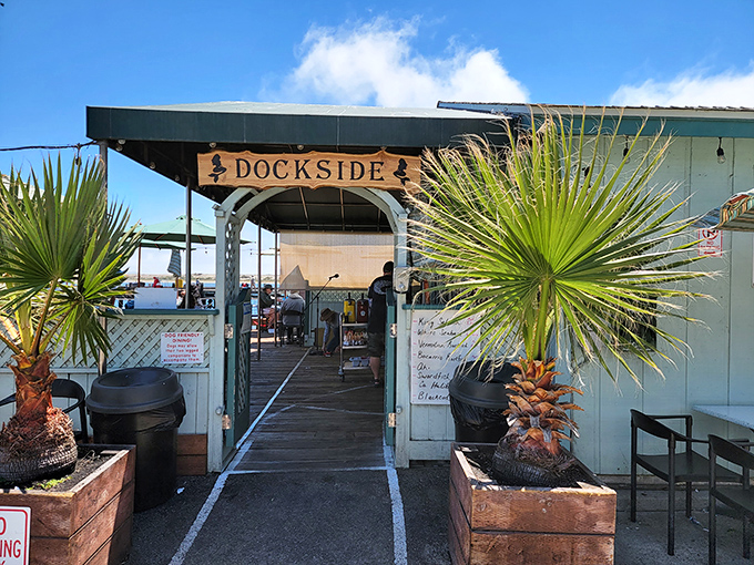 The entrance says it all: you're not just walking into a restaurant, you're stepping into a California coastal institution flanked by palm sentinels.