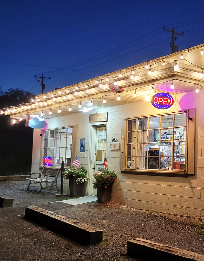 As evening falls, string lights transform this humble eatery into a roadside beacon of culinary comfort. Like a lighthouse, but for hungry people.