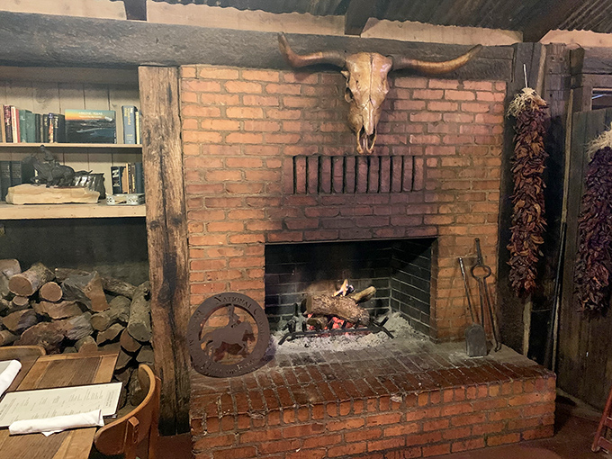 A fireplace that's seen its share of Texas tales. The longhorn skull above silently approves of the mesquite-scented conversations below.