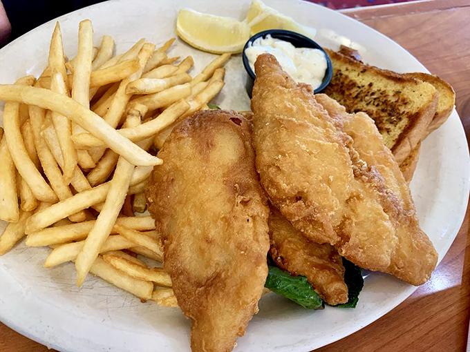 Fish and chips that would make a British pub proud, served with a side of American generosity. That toast isn't messing around either.