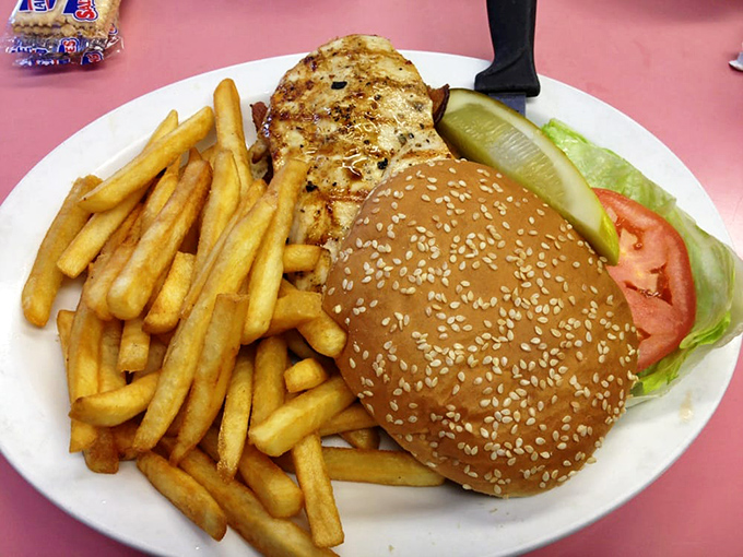 A burger and fries platter that doesn't need fancy aioli or truffle oil&mdash;just honest ingredients and a pickle spear standing guard.