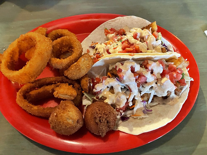 Fish tacos flanked by golden onion rings&mdash;a coastal combo that makes you wonder why you'd ever order anything else.