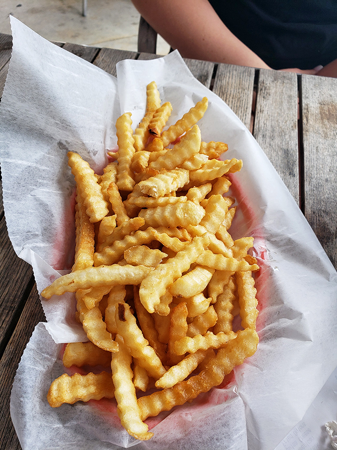 These aren't just fries—they're golden, crispy vehicles for ketchup delivery that somehow disappear faster than you can say "just one more."