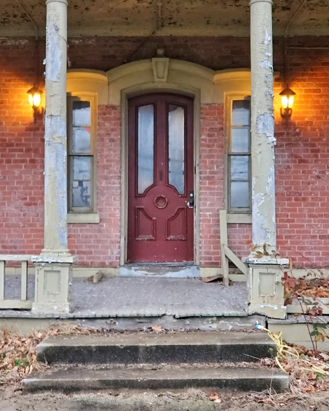 The front entrance—both welcoming and forbidding. This weathered door has seen thousands pass through, many never to return to the outside world.