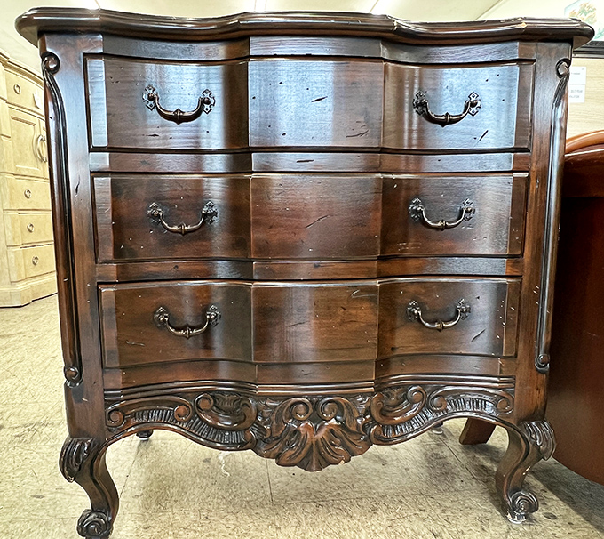 This ornate dresser whispers tales of elegant bedrooms past. Solid wood craftsmanship that would cost a fortune new waits for its next chapter.