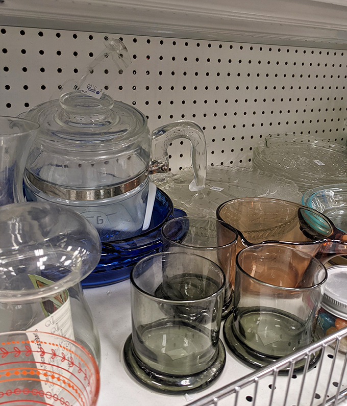 Vintage glassware catches the light, each piece whispering stories of dinner parties past and cocktail hours yet to come.