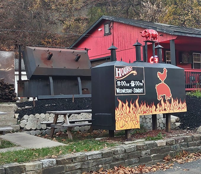 Hours posted on a sign that's appropriately flanked by flames. In the barbecue world, time isn't measured by clocks, but by when the meat is ready.