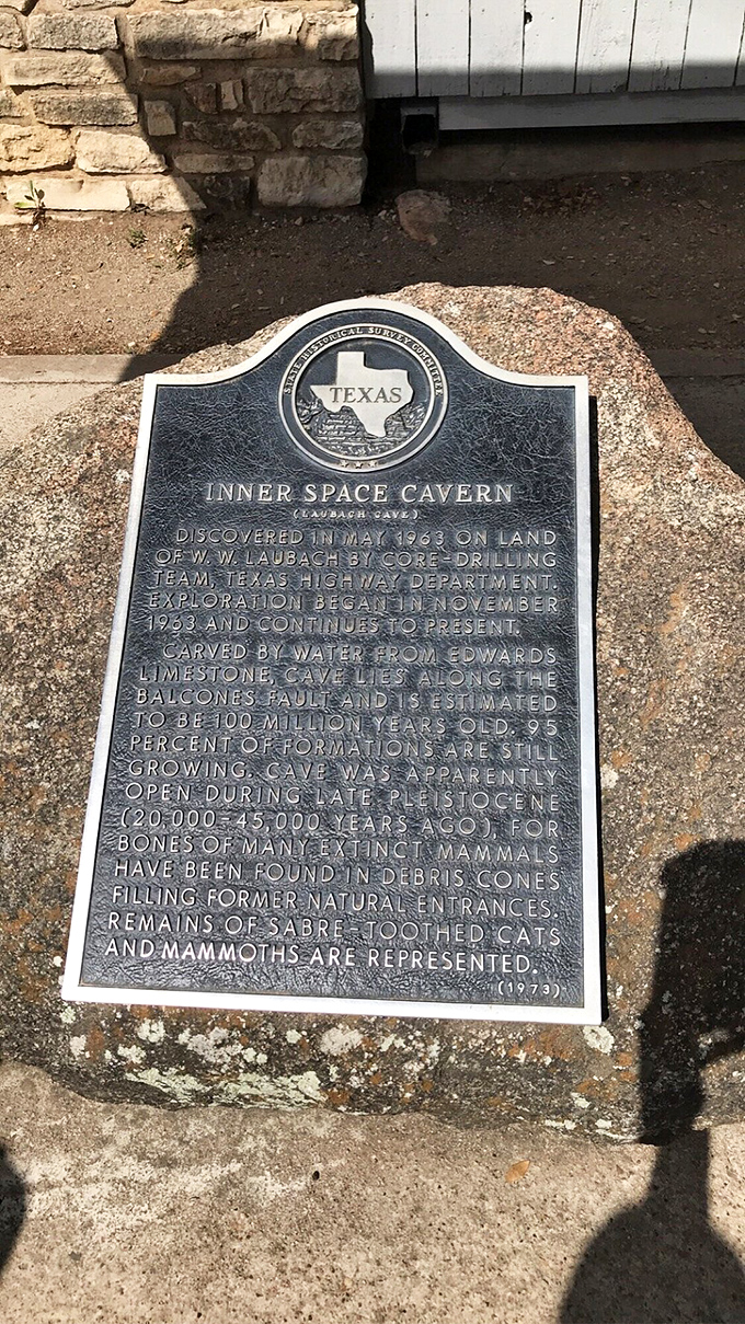 The official Texas historical marker reveals the cave's accidental discovery in 1963 during highway construction&mdash;proof that some detours lead to wonders.