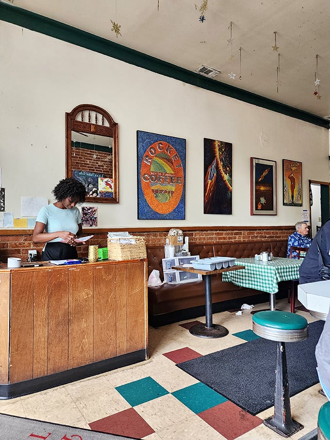 Art adorns the walls while servers navigate the narrow space with practiced grace. That brown leather booth has probably heard more secrets than a confessional.