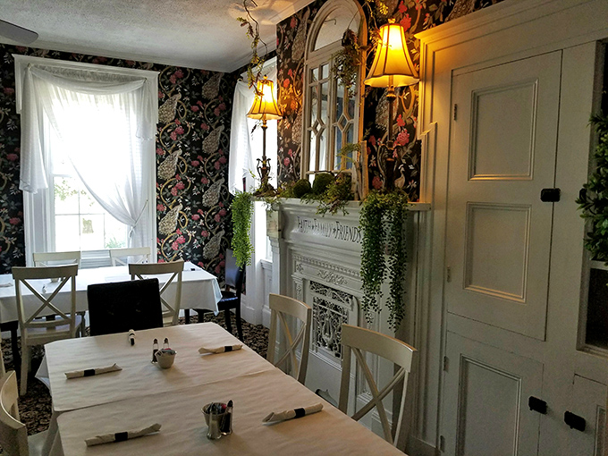 Floral wallpaper and elegant white trim create a dining room that feels like your fancy aunt's special occasion space&mdash;but with better food.