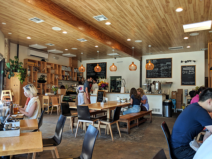 The warm glow of pendant lights illuminates a space where food memories are made. Simple wooden tables invite you to focus on what really matters—what's on your plate.