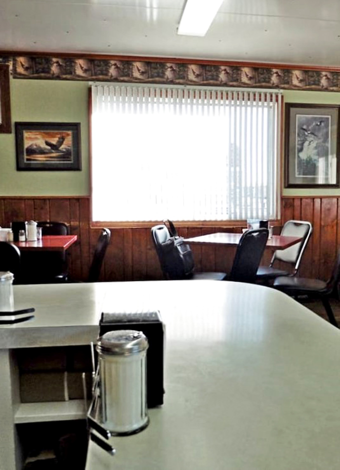 Eagle artwork watches over diners like a patriotic guardian angel. The wood-paneled walls have absorbed decades of local gossip and coffee steam. 