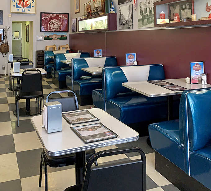 Classic blue booths lined up like loyal soldiers, ready to cradle hungry diners in mid-century comfort.