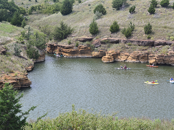 Kayakers exploring hidden coves where sandstone meets water. Social distancing at its most beautiful&mdash;just you, your paddle, and endless serenity.