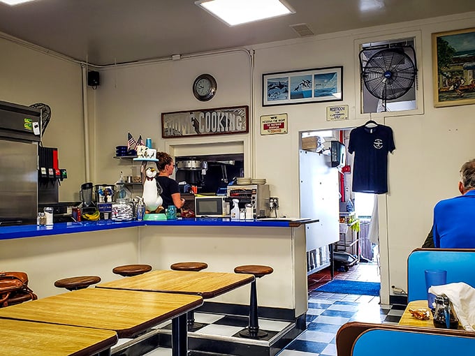 Behind the blue counter, breakfast magic happens with the efficiency of a well-rehearsed orchestra and the soul of a family kitchen.