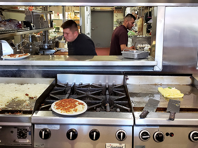 The kitchen ballet in full swing—where short-order cooks perform the daily miracle of turning simple ingredients into memory-making meals.