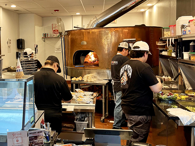 Behind the scenes, pizza wizards perform their delicious alchemy, transforming simple ingredients into wood-fired gold.