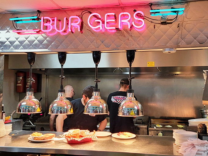 Under the pink neon "BURGERS" sign, cooks orchestrate a sizzling symphony on the flat-top &ndash; the kitchen equivalent of watching Hendrix play guitar.