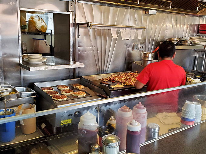Behind the scenes magic – where pancakes achieve golden perfection and potatoes transform from humble spuds to breakfast royalty.