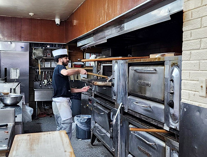 Behind every great pizza is a kitchen warrior with a wooden paddle, coaxing magic from decades-old ovens that remember your grandparents' orders.