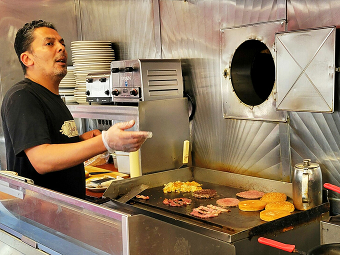 The griddle maestro orchestrates a symphony of sizzling proteins and golden pancakes with the confidence of someone who's seen it all. 