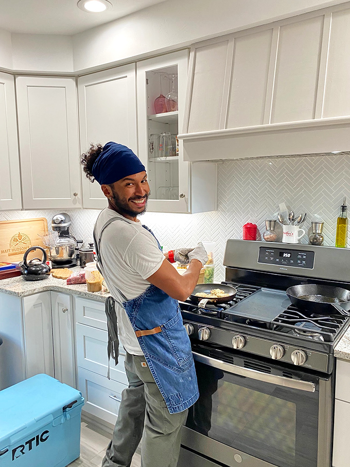 This image appears to be from someone's home kitchen rather than Leon's restaurant, showing a person cooking at a residential stove.