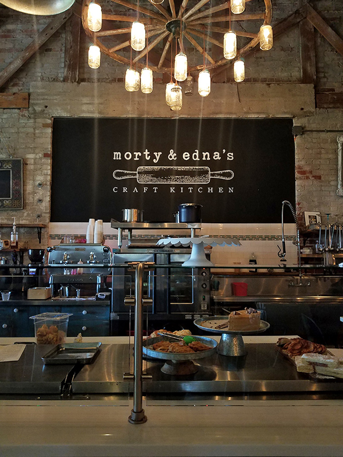 The heart of the operation: mason jar lights illuminate the open kitchen where the Morty & Edna's logo presides over culinary creativity.