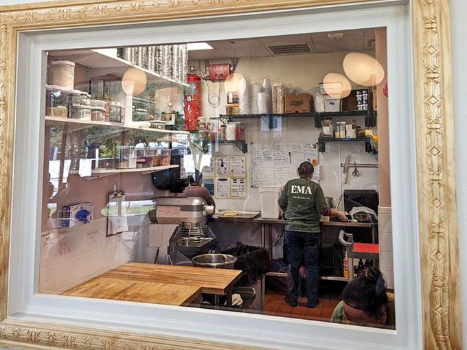 Behind the ornate frame: culinary artistry in action. The kitchen ballet that transforms simple ingredients into extraordinary experiences.