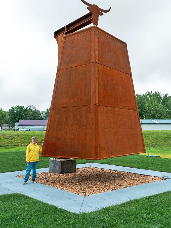 The cowbell's scale becomes clear when you see actual humans standing beside this towering monument.